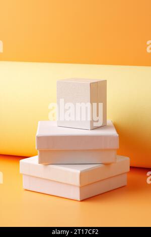 Three closed white jewelry boxes on yellow background Stock Photo - Alamy