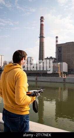 Man flying drone at a river Stock Photo - Alamy