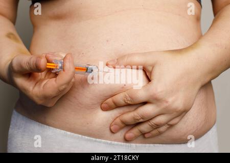 In Vitro Fertilization injection pen held in hand of white background ...