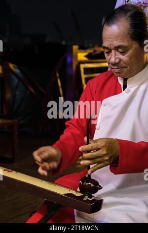 Vietnamese Musician Playing the Dan Bau Stringed Instrument, Ho Chi ...