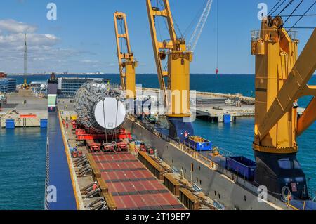 Off-shore oil platform stairwell being loaded on to a ship for ...