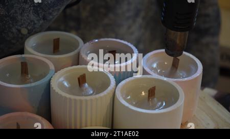 The process of processing finished candles with a hair dryer to level ...