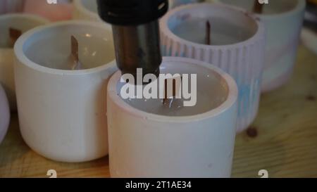 The process of processing finished candles with a hair dryer to level ...