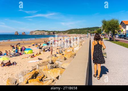 Hendaye beach one summer afternoon full of people enjoying the water in ...