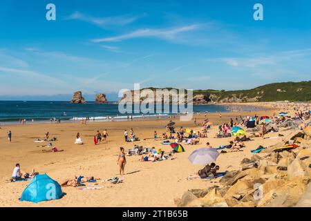 Hendaye beach one summer afternoon full of people enjoying the water in ...