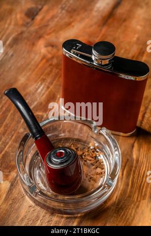 New hip flask and smoking pipe isolated on white background Stock Photo ...