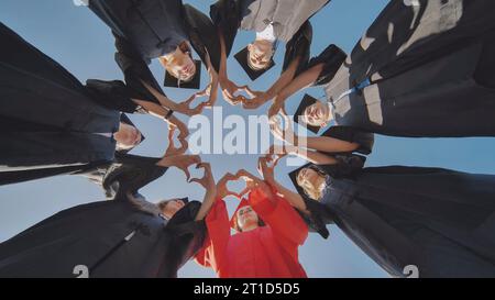 College graduates make a circle of their hands Stock Photo - Alamy