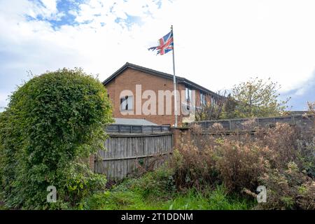 Ripped Union Jack on housing estate UK Stock Photo - Alamy
