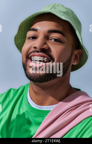 Handsome bearded man happily looking in camera over white background ...