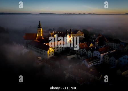 Aerial view of the historical centre of Telc on a foggy morning, with ...