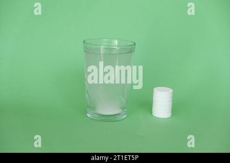 Water soluble C vitamin inside water with green background. Medical ...