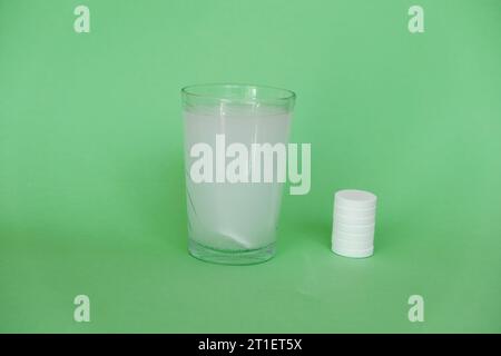 Water soluble C vitamin inside water with green background. Medical ...