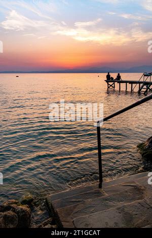 Lakeview at sunset from walkway at Cisano, Bardolino, Lake Garda, Italy ...