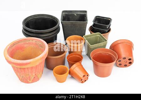 Different sizes and shapes of plastic pots for plants isolated on white ...