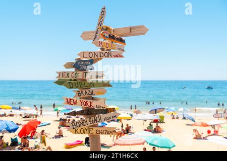 A town signs on the beach at Praia do Barranco das Belharucas ...