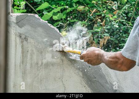 Hand of worker using hammer smashing and demolish on brick block wall ...