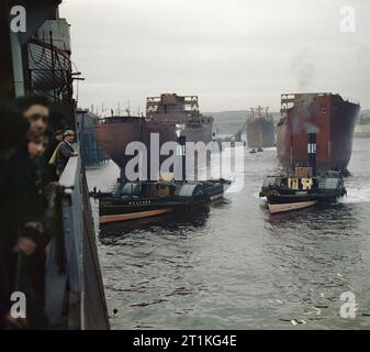 Shipbuilding in Belfast, 1943 Two recently launched ships being towed ...