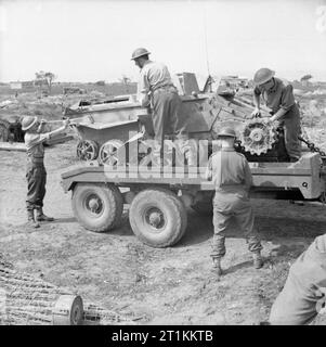 A captured German radio-controlled demolition tank is unloaded from a ...