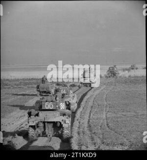 THE ATTACK ON CAEN - British Sherman tanks of A/T Brigade, 33rd Armoured Brigade passing through ...