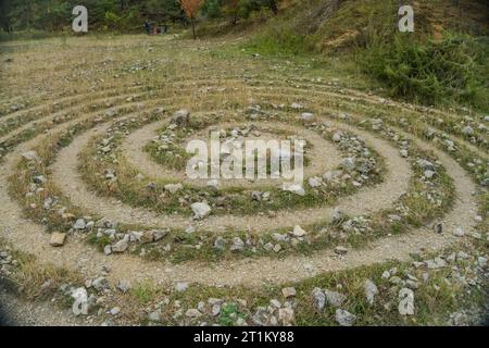 Circular labyrinths on the ground of grass and stones near the ...