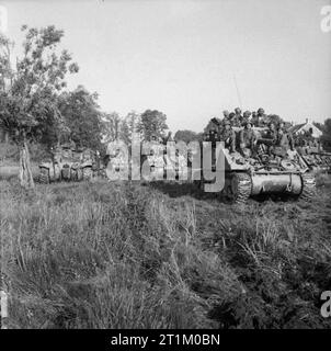 British infantry and Sherman tanks wait to advance at the start of ...