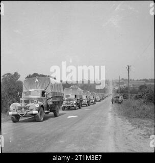 A British Army convoy of lorries moves under enemy artillery and mortar ...