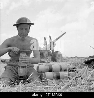 A gunner of the 80th Medium Regiment (Scottish Horse) fuses a 4.5-inch ...