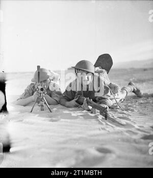 A Bren gunner and rifleman of the British Army take defensive positions ...