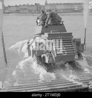 Humber armoured car of the 43rd (Wessex) Division enters water from a ...