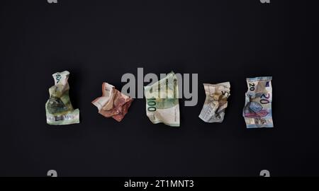 A pile of crumpled euro banknotes on a gray background. Minimalism ...