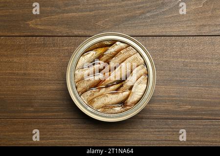 Sprats in tin can on grey textured table, top view. Space for text ...