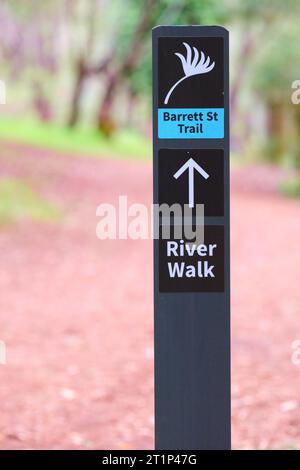 A sign indicating the Barrett Street walk trail by the river between ...