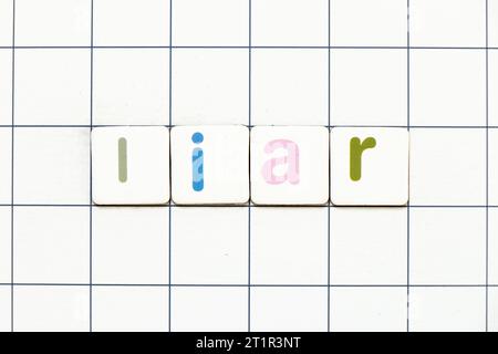 Tile alphabet letter with word falsify in red color rack on wood ...