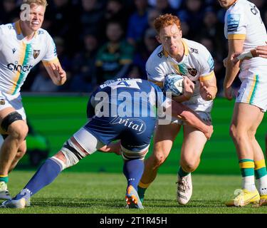 George Hendy #15 of Northampton Saints runs at Ernst Van Rhyn #4 of ...