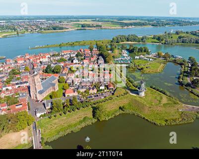 Aerial from the historical city Woudrichem at the river Merwede in the ...