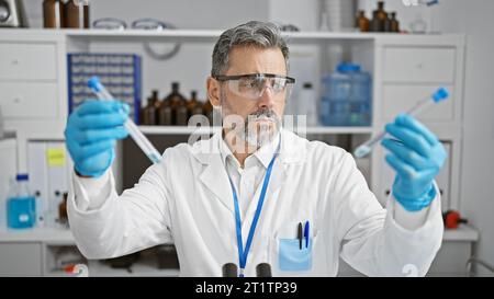 Young hispanic man scientist measuring liquid at laboratory Stock Photo ...