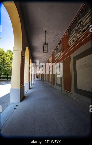 Promenade with long arcade columns surrounding Hofgarten Park in Munich ...