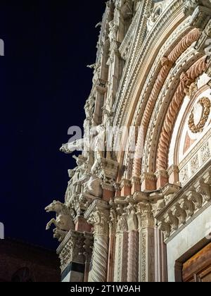 Looking up to the sone carvings covering the right corner of Siena ...