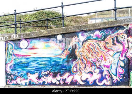 Seafront graffiti on a seawall at Herne Bay. An explosion ball of ...