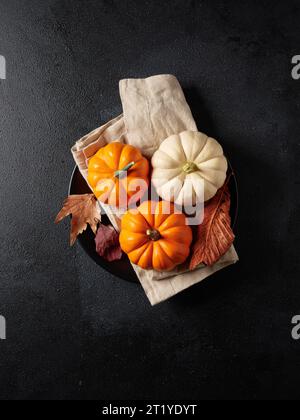 Autumn table setting with fallen leaves and pumpkin on grunge ...