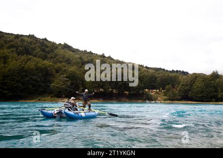 Two guys float on a raft, fly-fishing for trout Stock Photo - Alamy