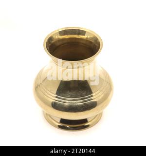 a clean golden indian brass vessel used as a water pot for traditional ...
