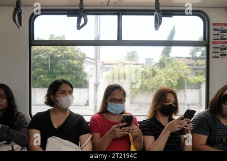 Manila, Philippines: Filipino commuters inside a cabin in a moving LRT ...
