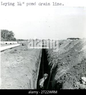Photograph showing construction of a fish hatchery raceway completed ...