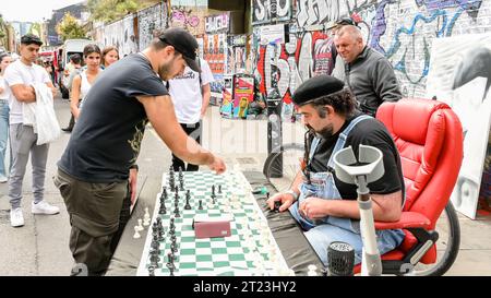 Man playing chess with passers by in Brick Lane, London Stock Photo - Alamy