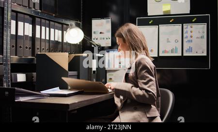 Private inspector reviewing clues on wall map Stock Photo - Alamy