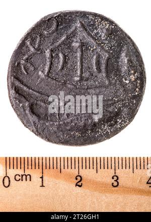 An ancient tin-zinc Siamese coin depicting a giant catfish.. Isolated ...