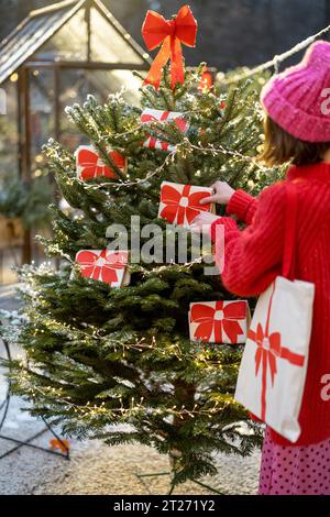 Beautiful Christmas tree and festive decor in bedroom. Interior design ...