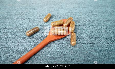Herbal capsules from bidara with leaf on blue denim background ...