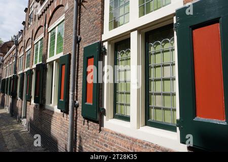 Traditional Dutch architecture houses with open windows in Amsterdam ...